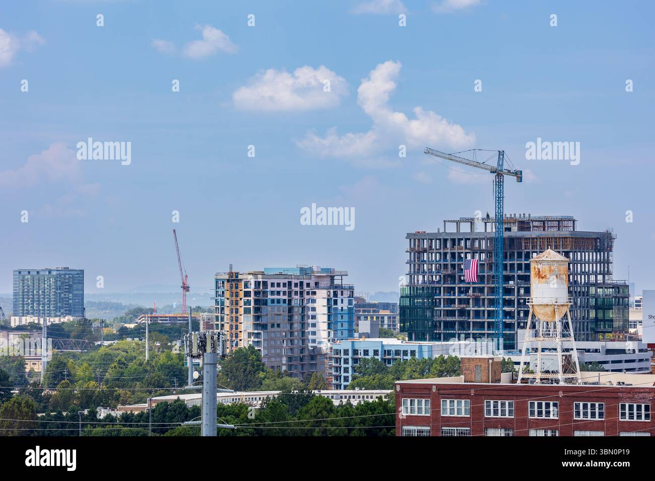 Construction cranes and unfinished high-rise buildings dot the ...
