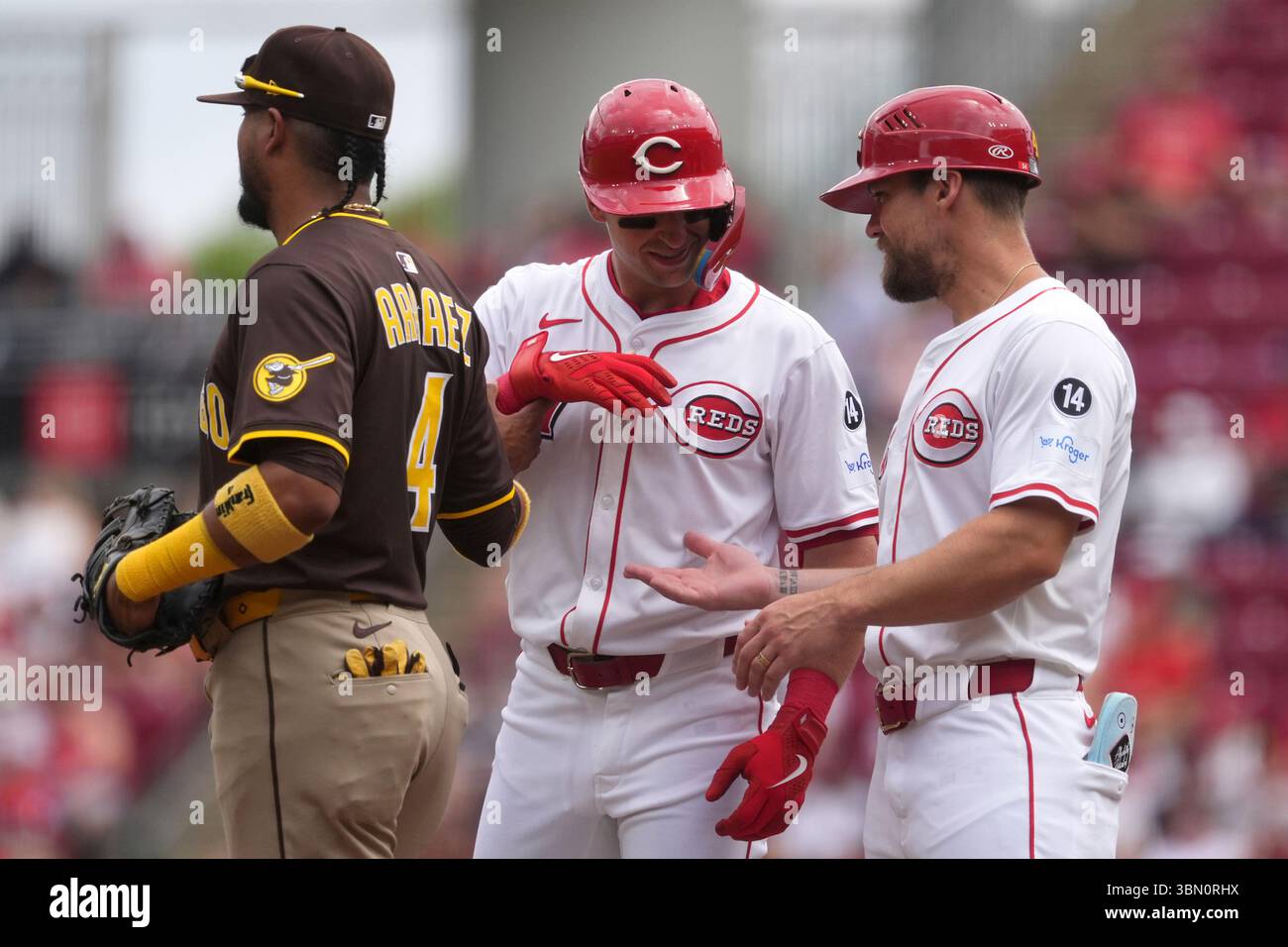 San Diego Padres' Luis Arraez, left, jokingly restrains Cincinnati Reds ...