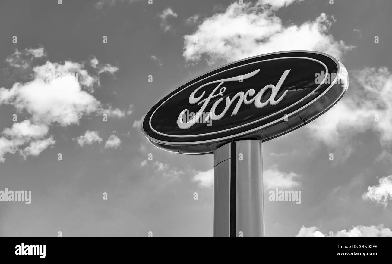 Chicago, USA - August 17, 2024: Ford logo sign against blue cloudy sky ...