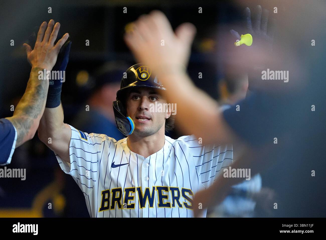 Milwaukee Brewers' Sal Frelick is congratulated in the dugout after ...