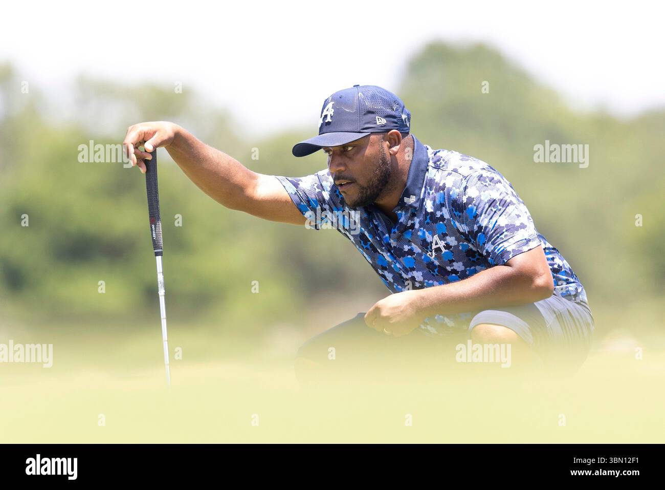 Harold Varner III of 4Aces GC reads his putt on the seventh green ...