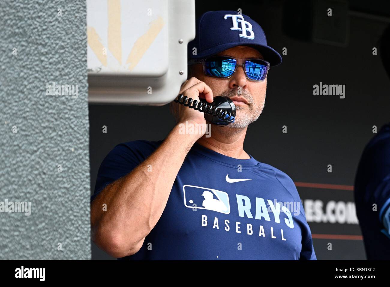 Tampa Bay Rays manager Kevin Cash talks on the dugout phone before a ...