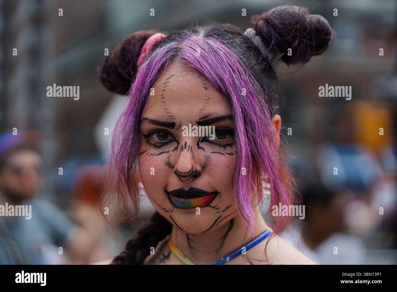 Reveler wears face paint while walking in the NYC Pride March, Sunday, June 29, 2025, in New ...
