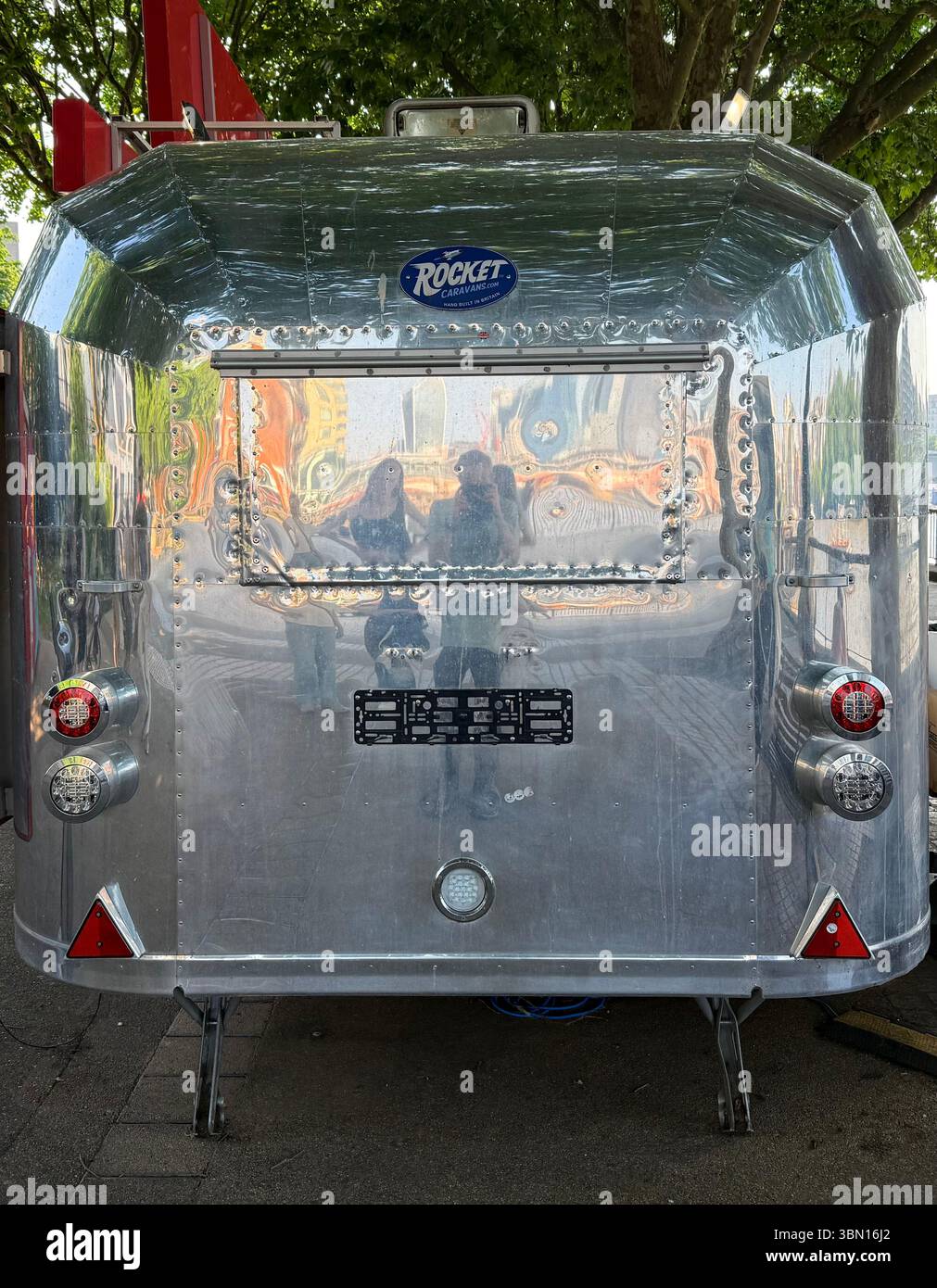 Reflections in back of silver metal airstream like catering caravan on ...