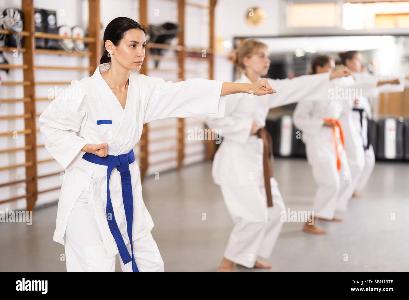Women students repeat position and perform sequence of punches and ...