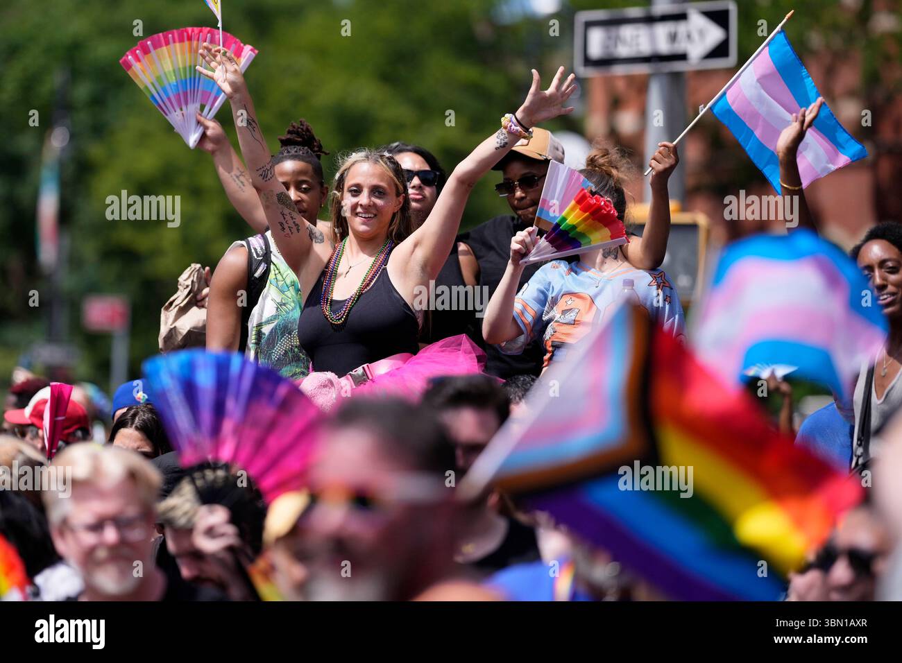 Spectators cheer on parade-goers during the NYC Pride March, Sunday ...