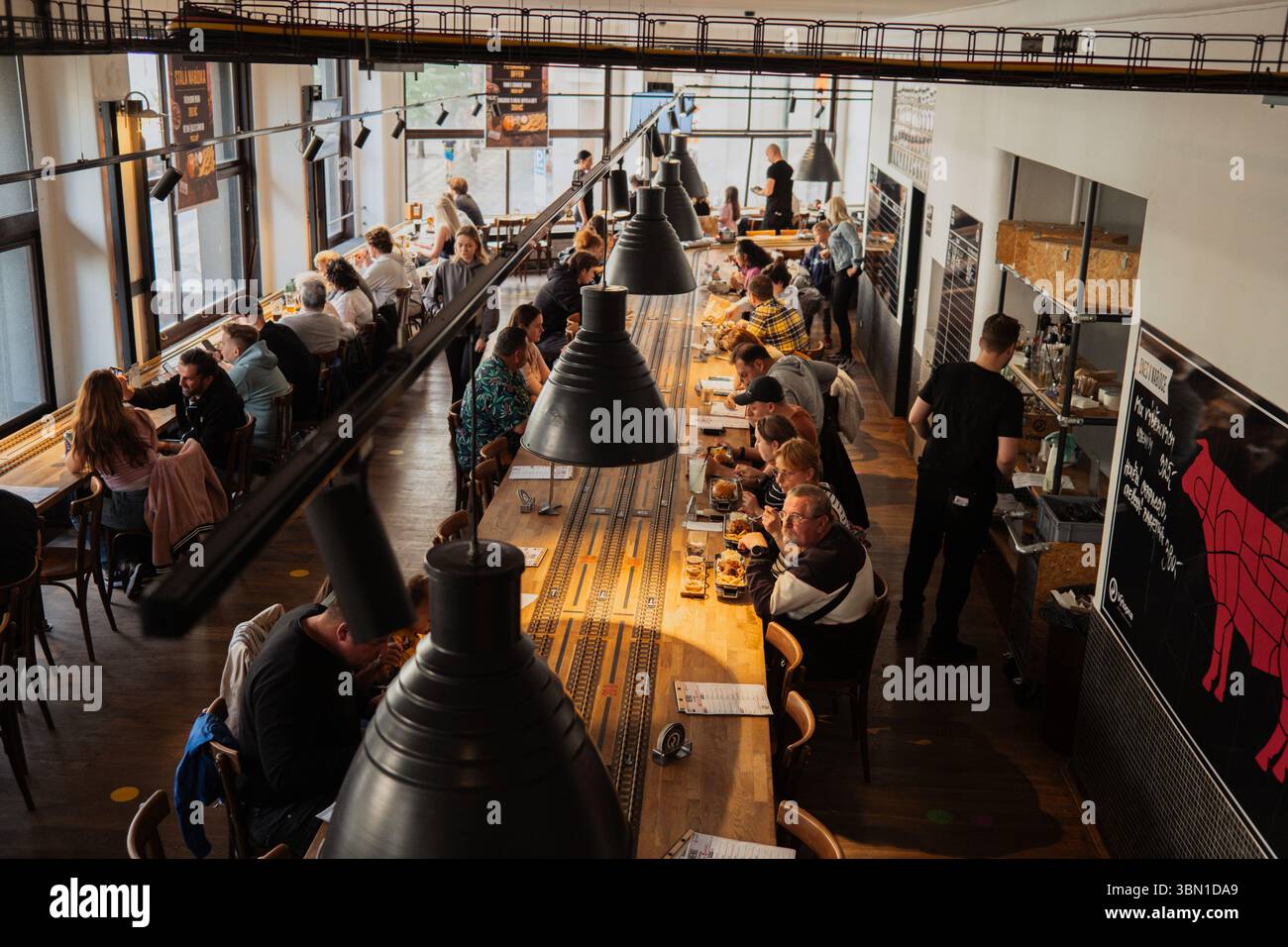 Prague, Czech Republic - June 29, 2025: People dining inside the famous ...