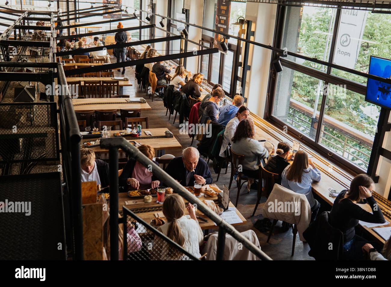 Prague, Czech Republic - June 29, 2025: People dining inside the famous Vytopna Railway ...