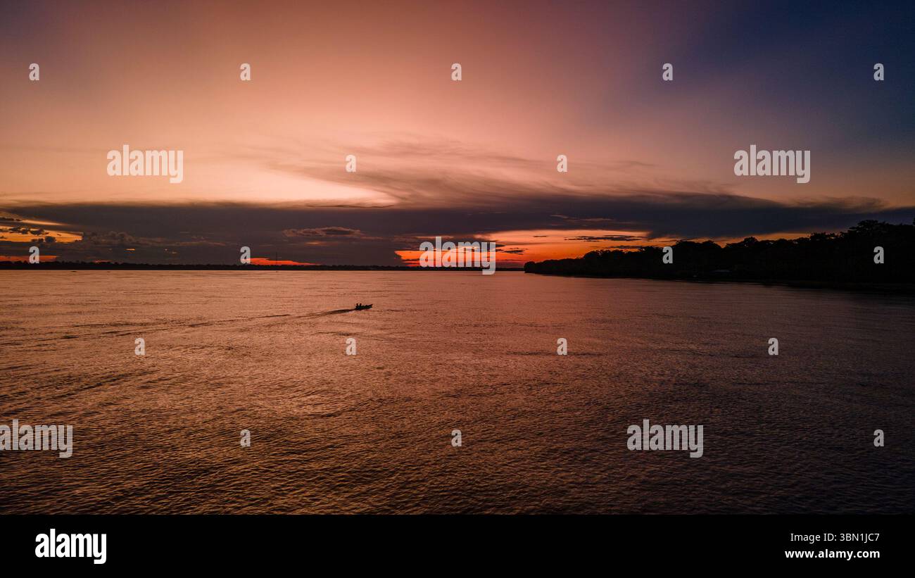 A tranquil sunset scene over the Amazon River in Leticia, Colombia ...