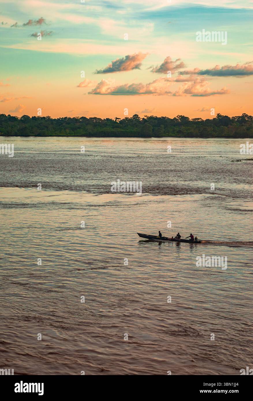A tranquil scene of a boat with four people navigating the Amazon River ...