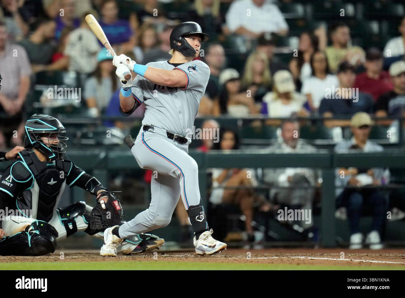 Miami Marlins' Kyle Stowers, right, watches the flight of his three-run ...