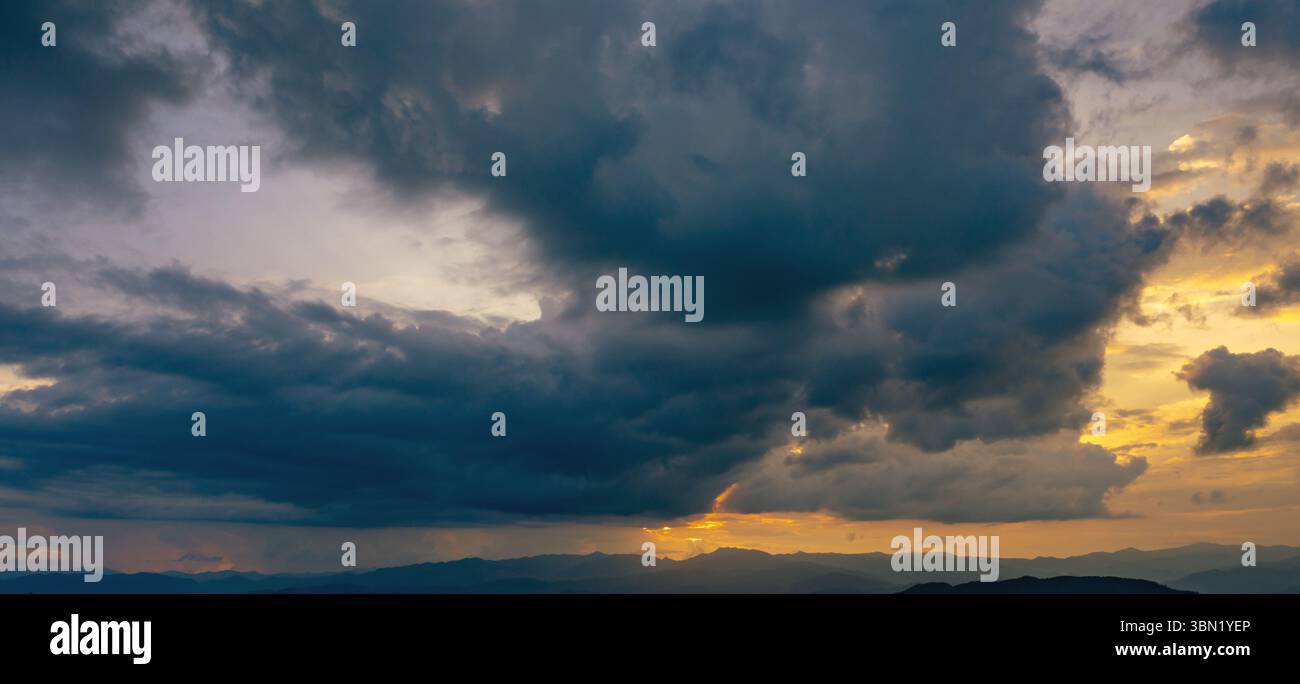 Dramatic overcast sky panorama with gray storm clouds during golden ...