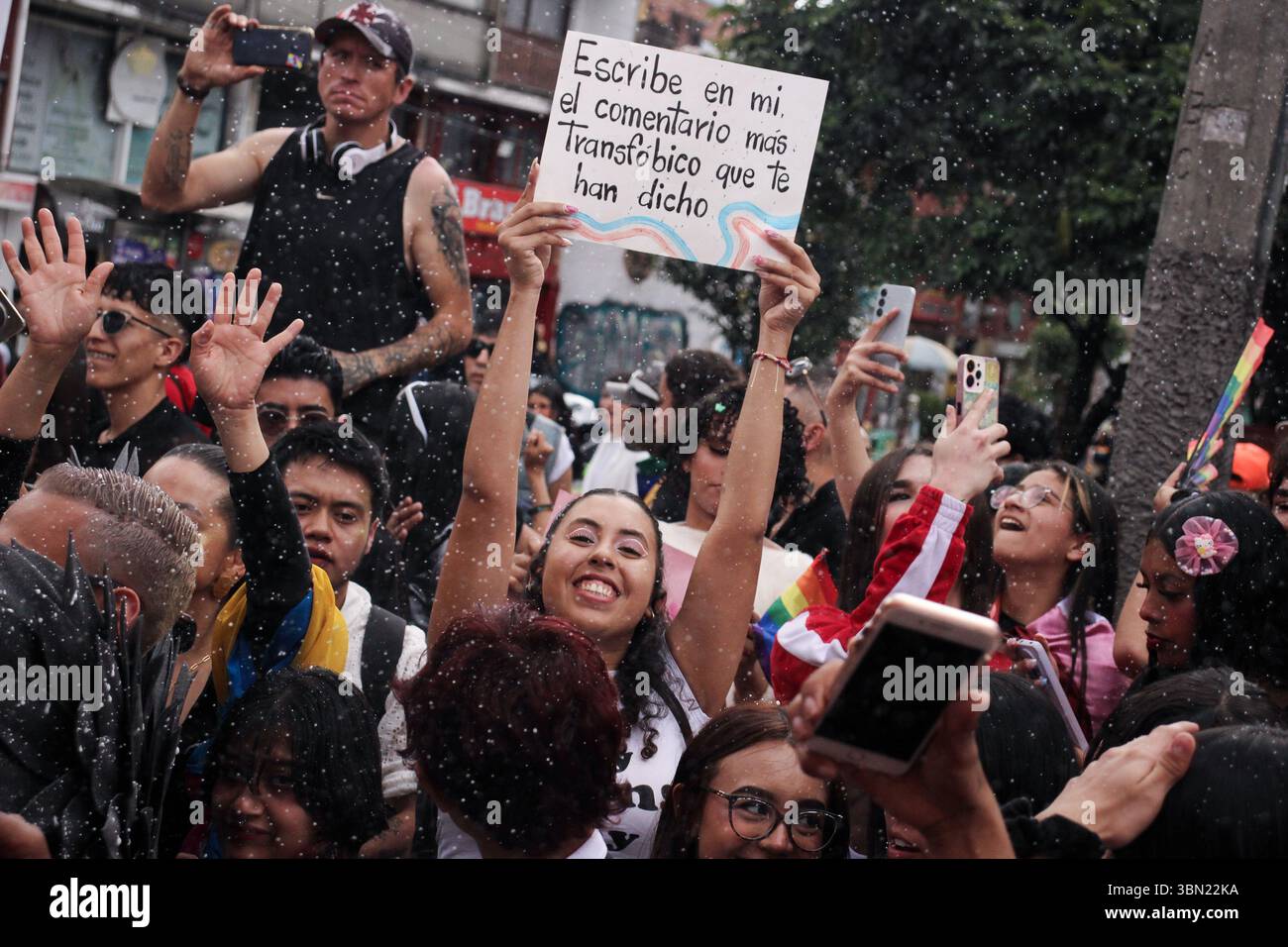 Demonstrators wave pride flags, signs and messages in support as ...