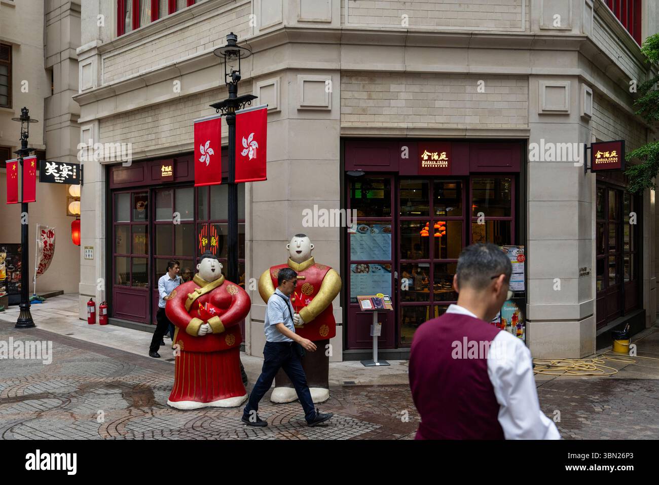 Chinese and Hong Kong SAR flags are hung outside a restaurant in Hong ...