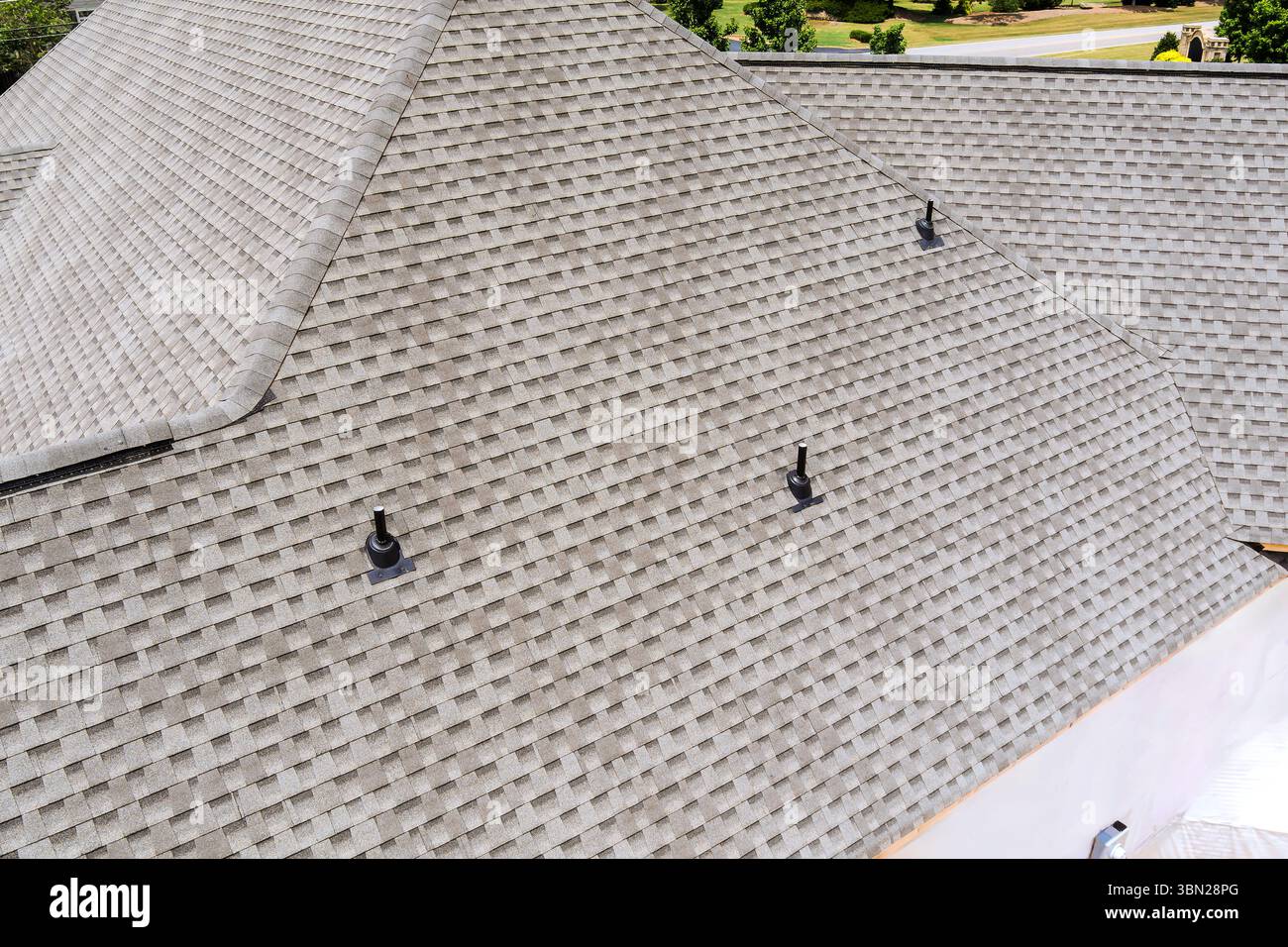 New shingles are being installed on steep sloped residential roof ...