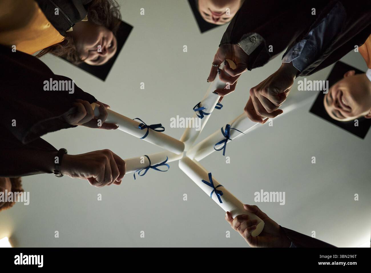 Group of diverse young university students wearing graduation caps ...