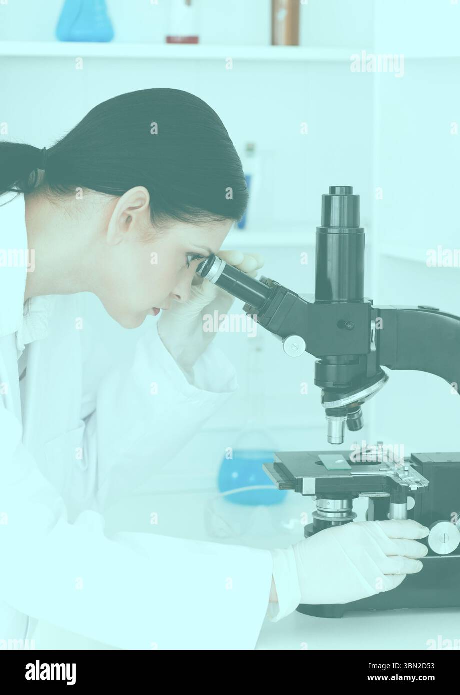 Female scientist looking through a microscope Stock Photo - Alamy