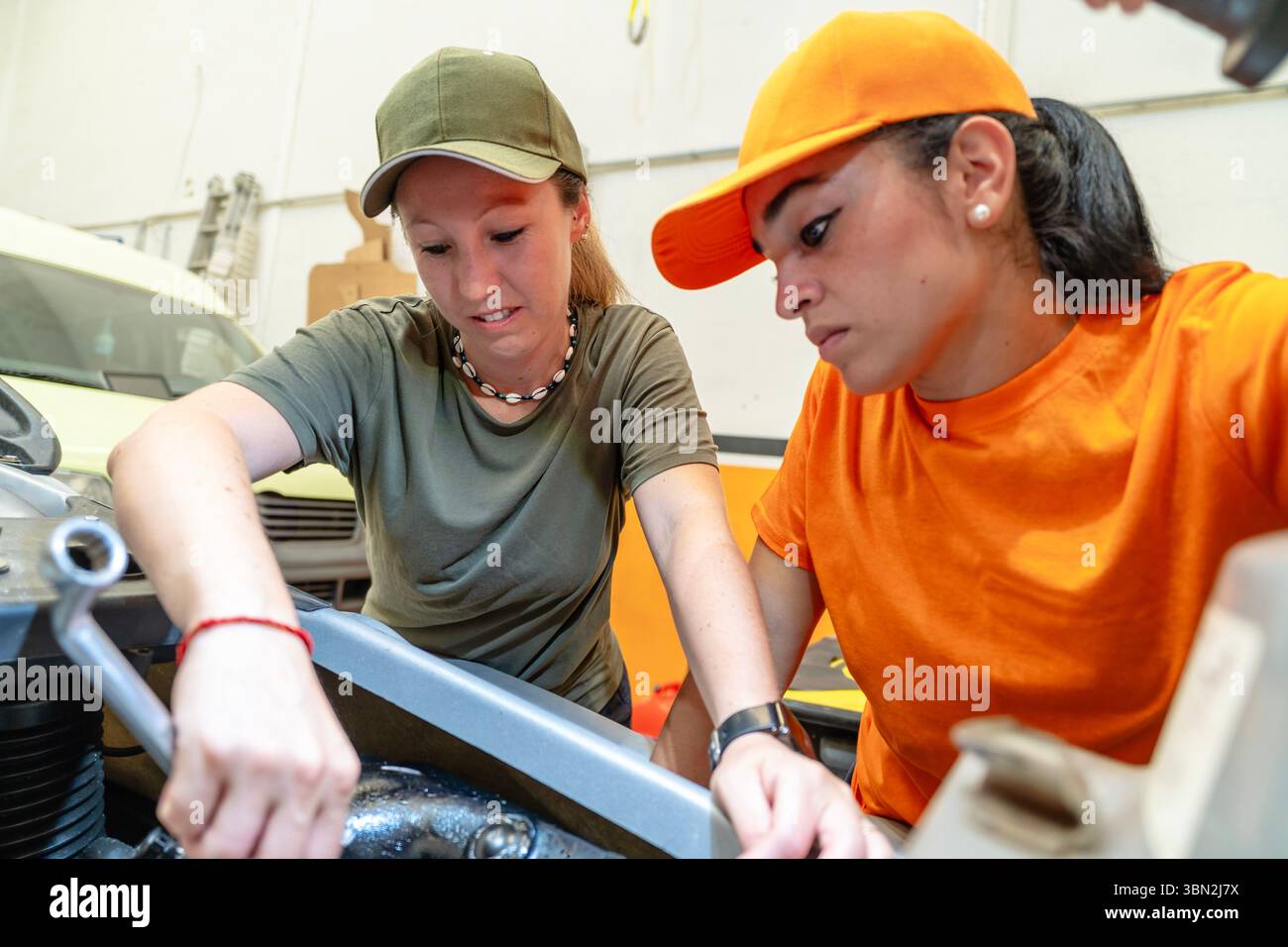 Two mechanics collaborate repair motor hi-res stock photography and ...