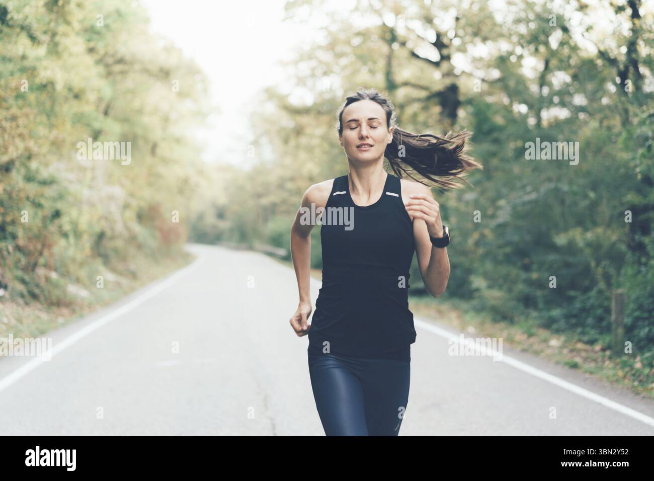 Girl in sportswear jogging forest hi-res stock photography and images ...