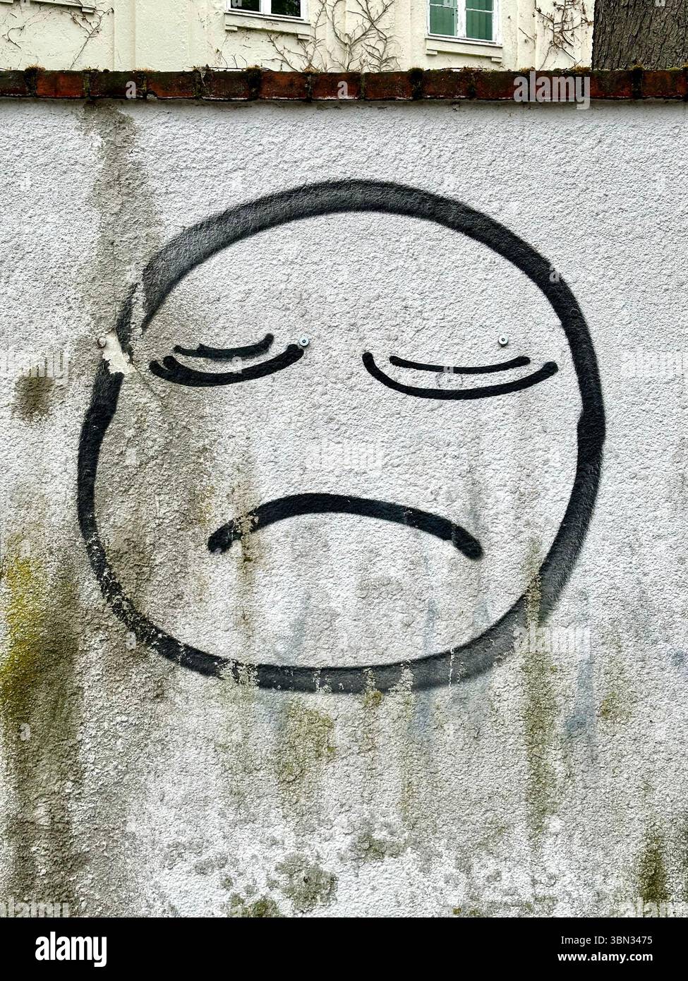 A graffiti of a sad face Stock Photo - Alamy