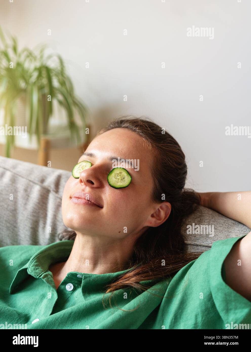 Woman on sofa cucumber face hi-res stock photography and images - Alamy