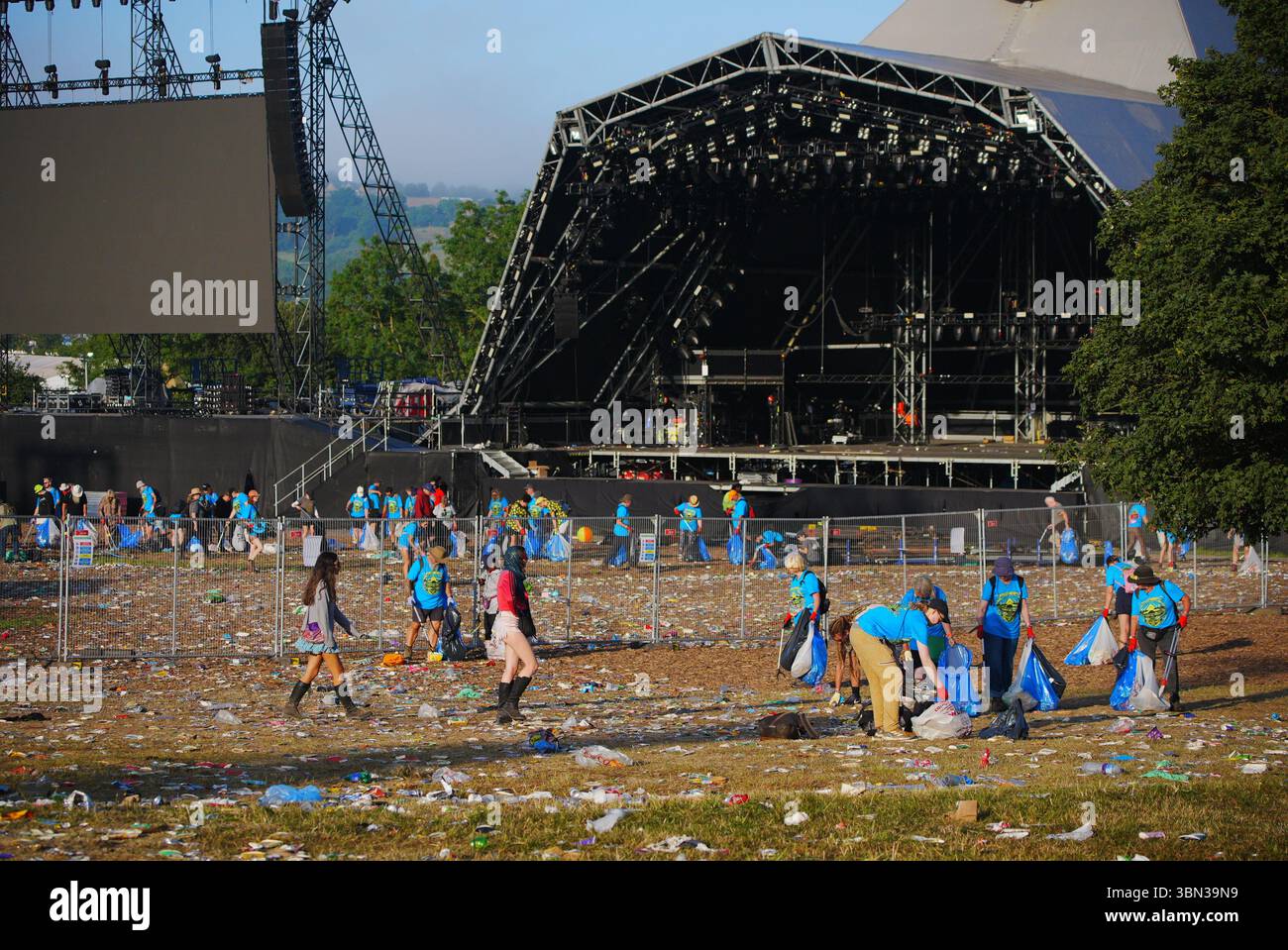 The clean up operation begins in a field covered in litter at the end ...