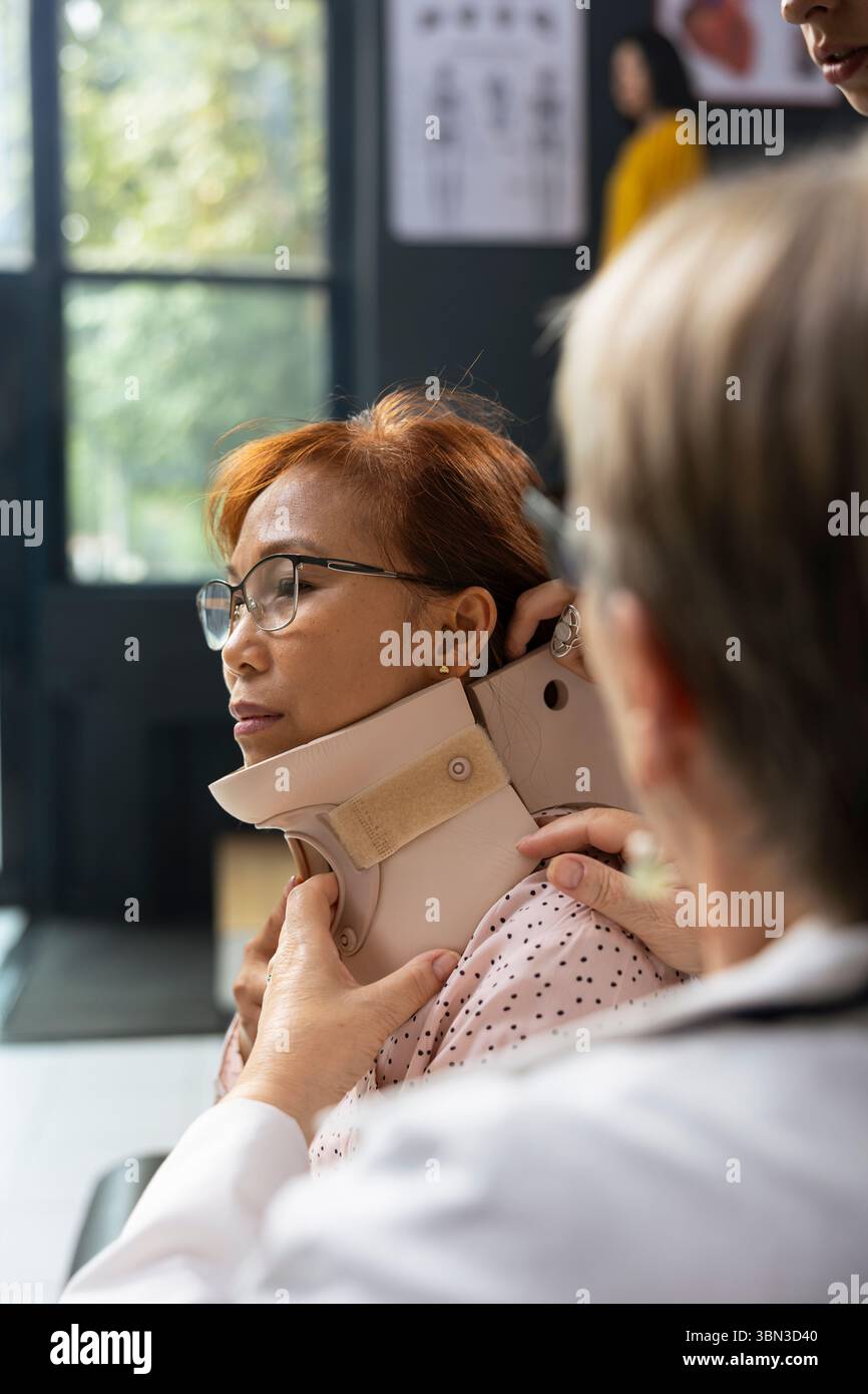 Medical staff fixing cervical collar on woman with signs of neck trauma ...