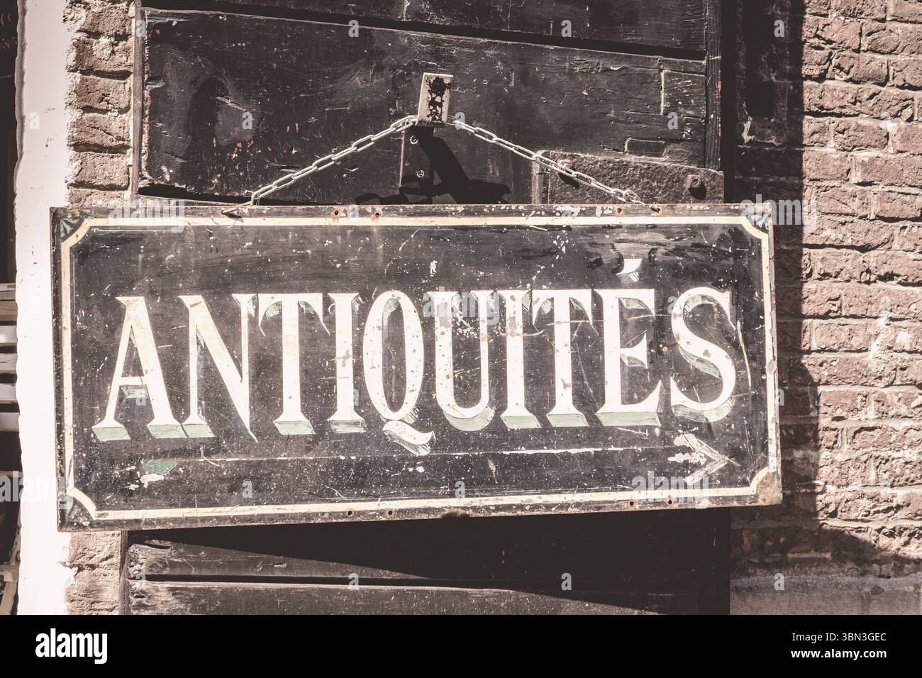 Antiques sign on an old brick building Stock Photo - Alamy