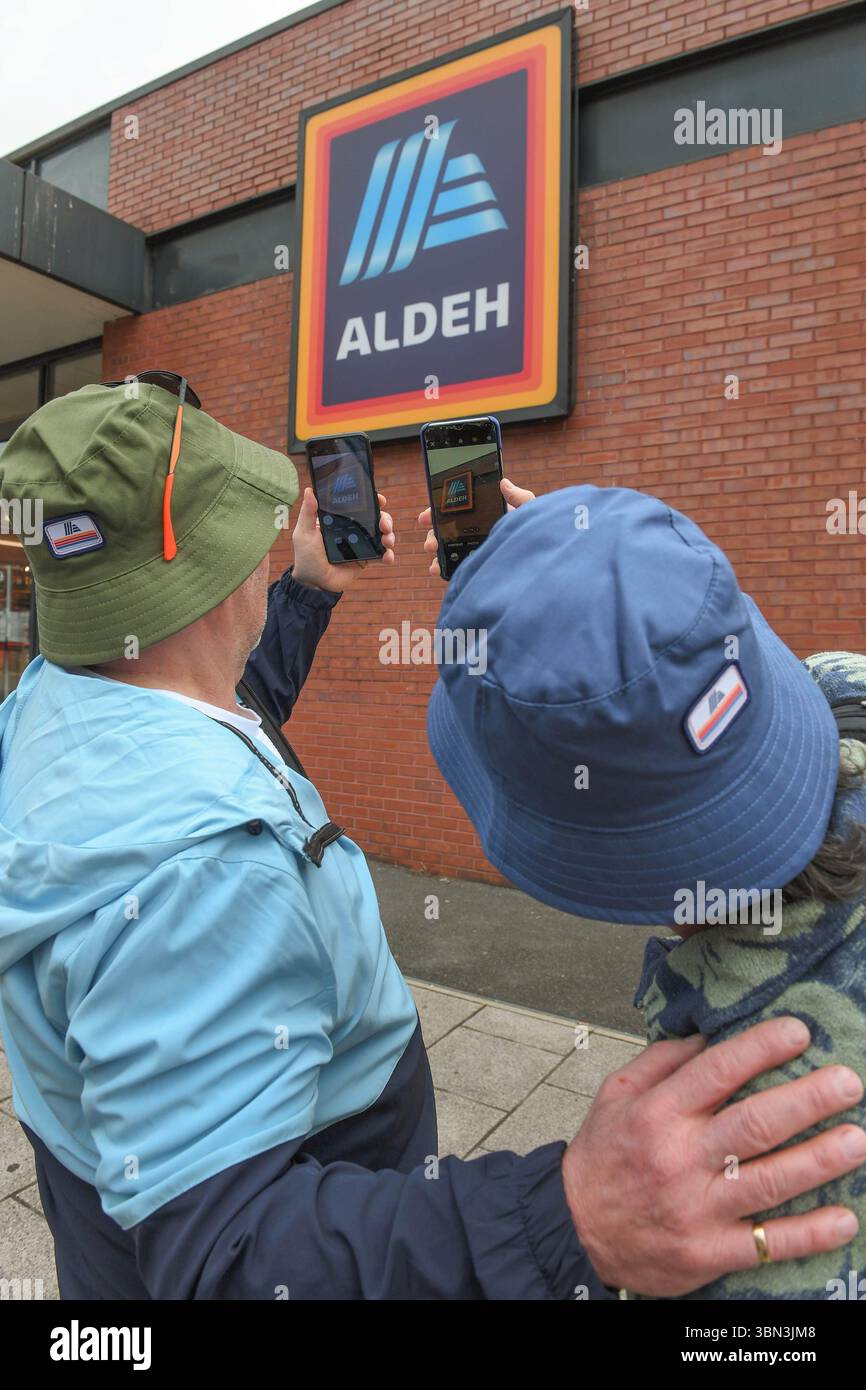 EDITORIAL USE ONLY Shoppers and passerbys outside of the Aldi store in ...