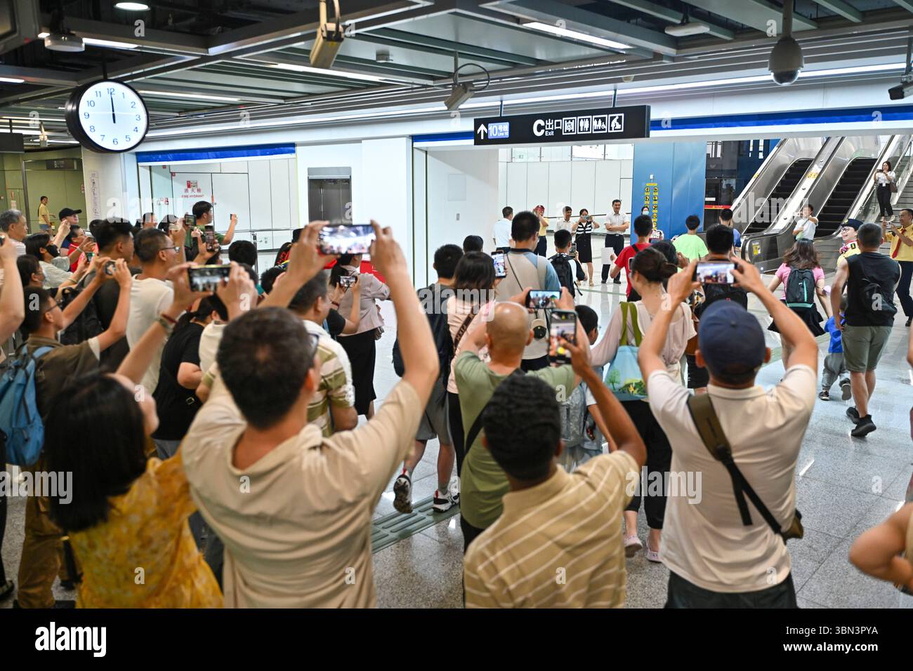 Passengers document the opening moment at Donghu Station on Metro Line ...
