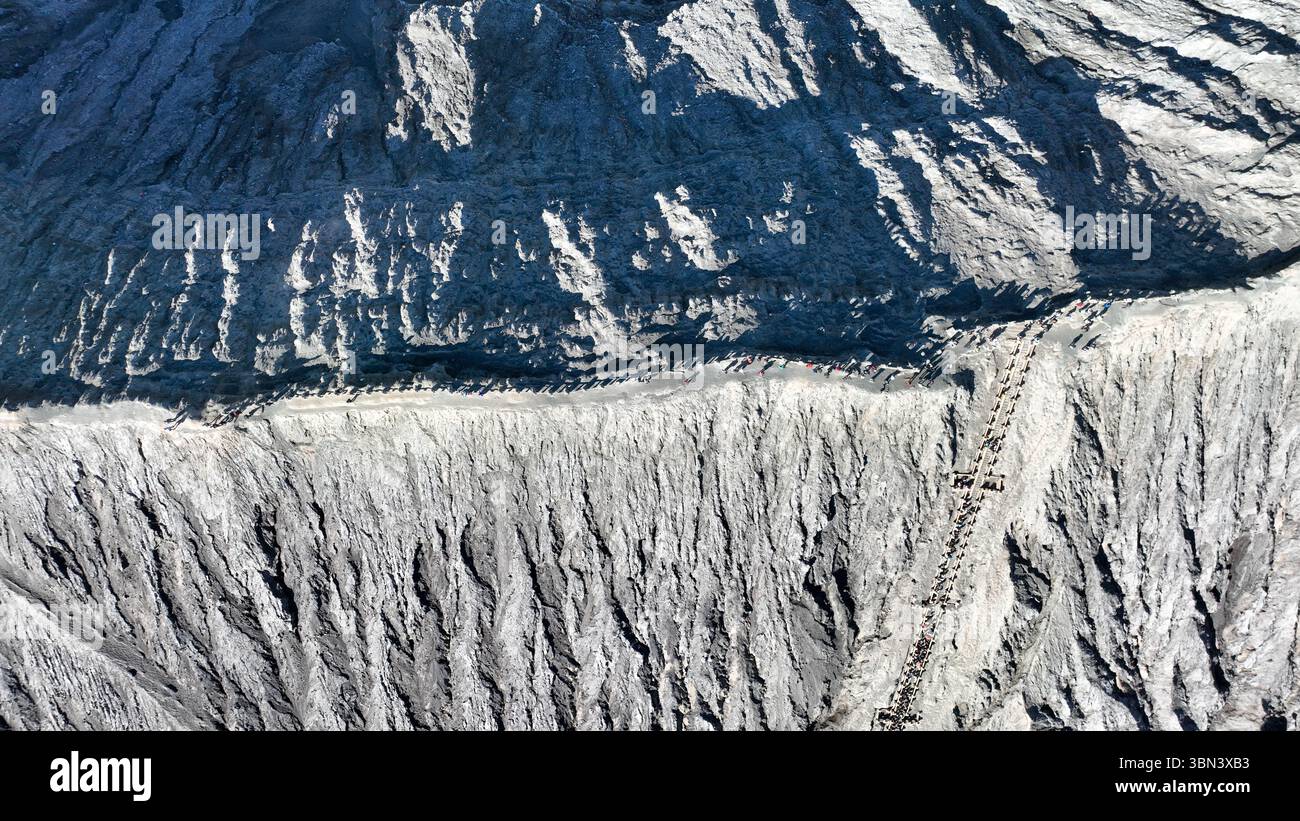 A line of adventurous visitors climbs the narrow staircase along the ...
