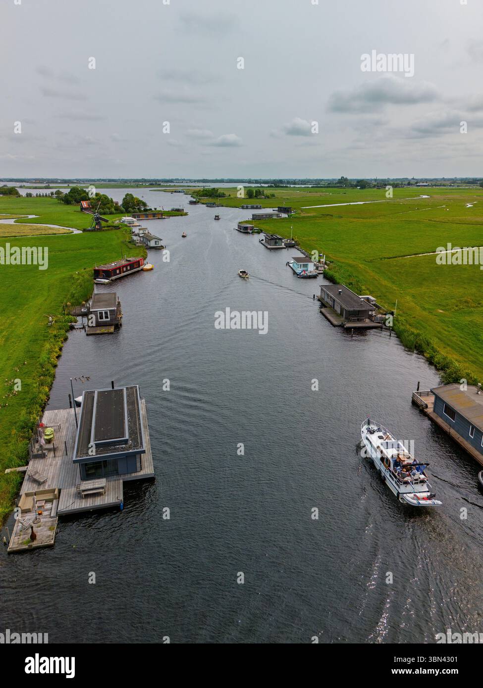 A top-down view of a marina with multiple boats docked along wooden ...