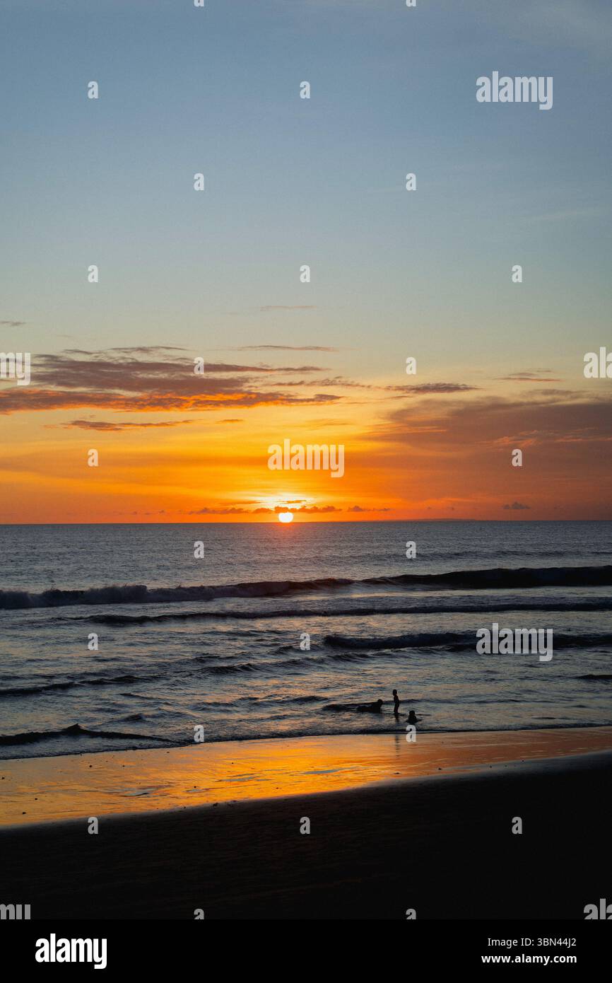Tropical beach sunset, ocean waves and golden reflections on wet sand ...