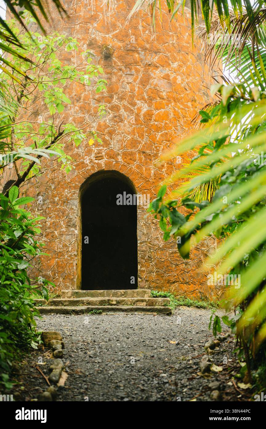 Stone tower entrance surrounded by jungle in El Yunque, Puerto Rico ...