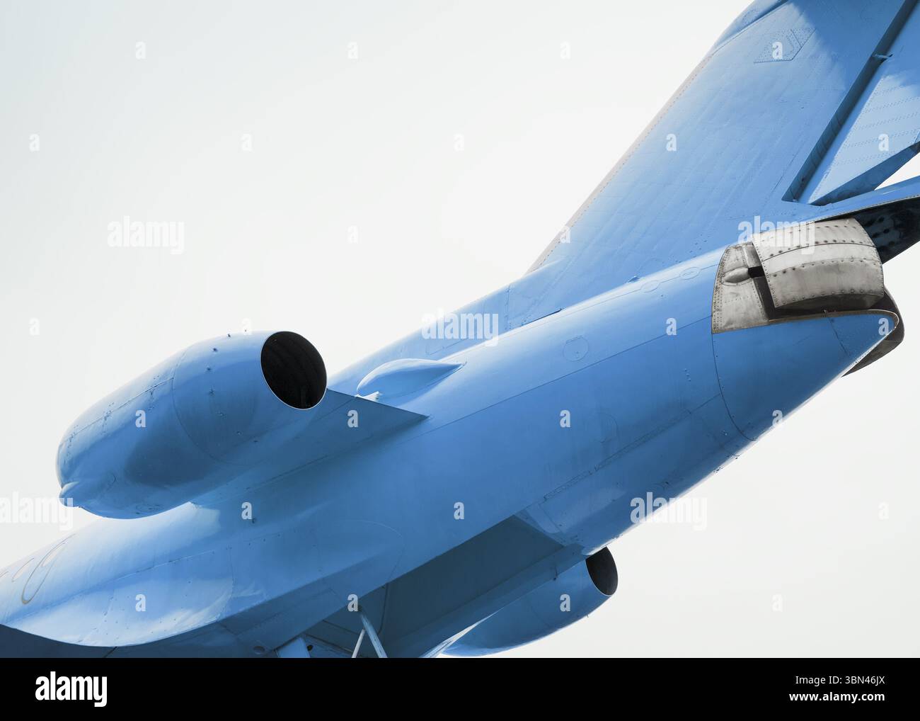Empennage of business jet plane. Tail section of cyan blue regional jet ...