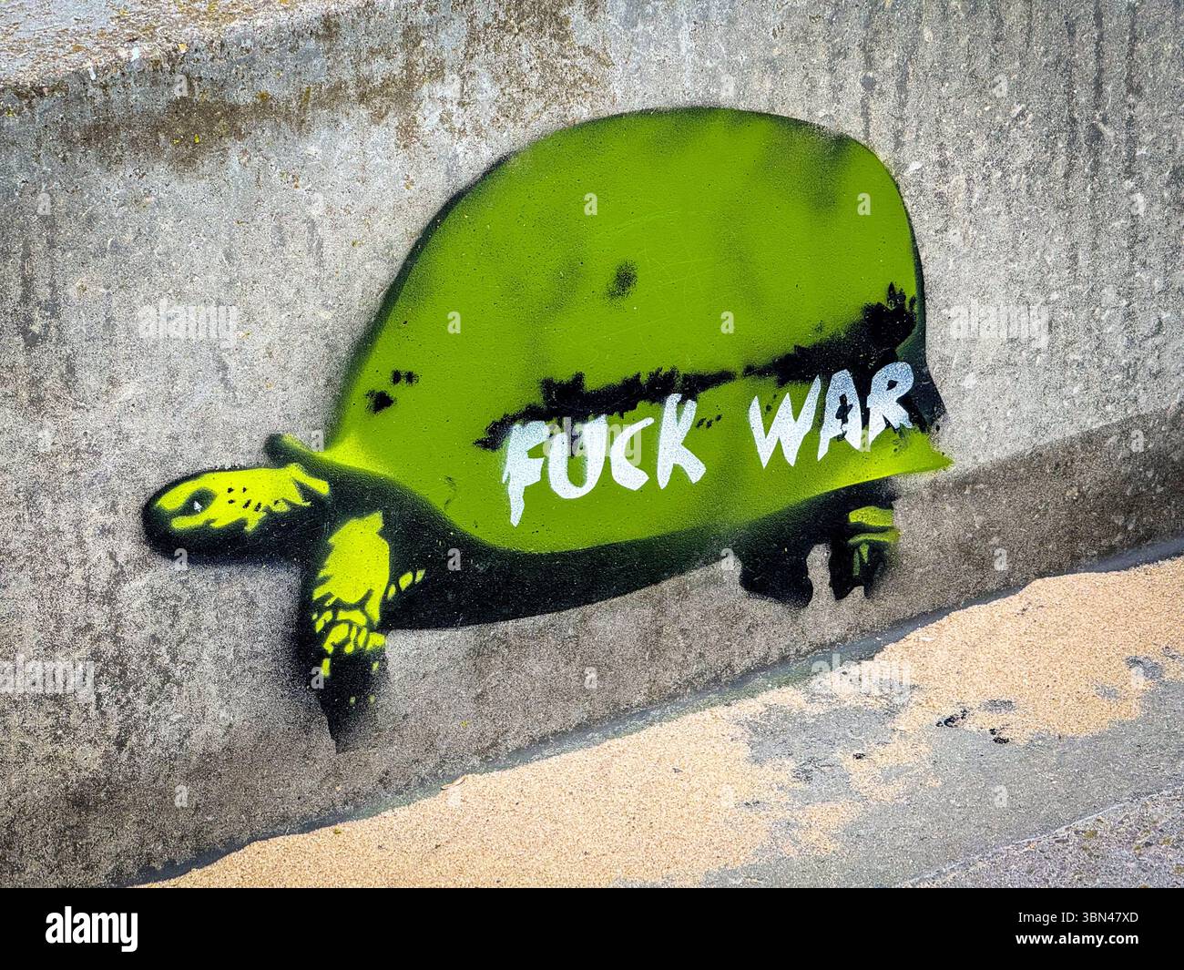 Stencil graffiti with turtle helmet against war Stock Photo - Alamy