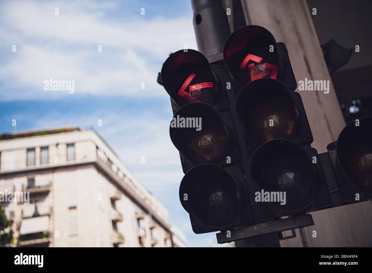 Traffic light displaying red arrows, signaling turning vehicles to stop ...