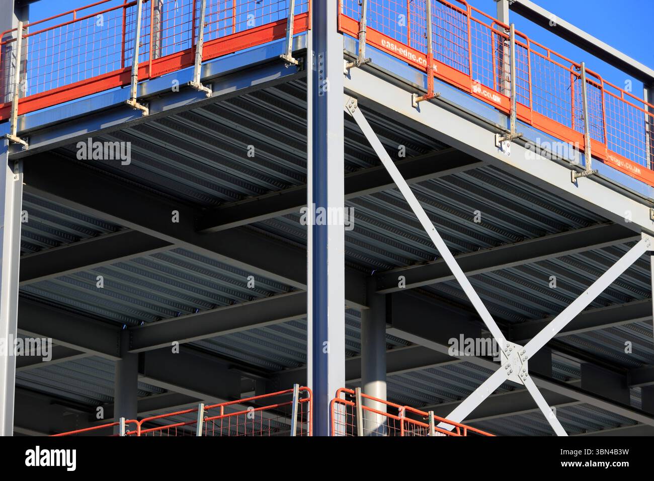 Radcliffe civic hub, steel skeleton frame, and underside of metal composite deck and orange edge ...