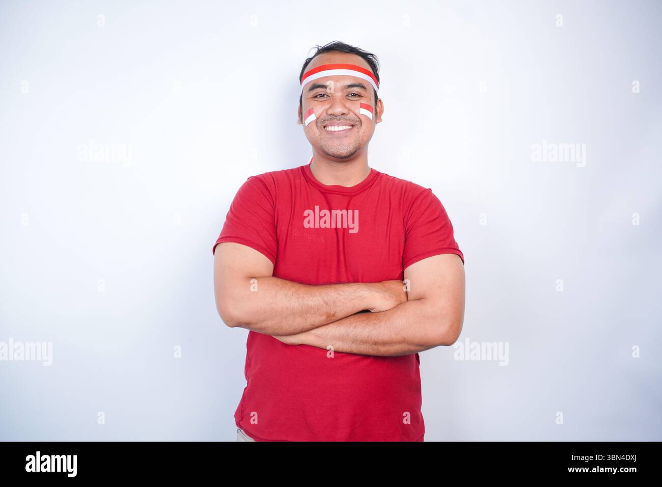 Smiling happy young Asian man giving salute gesture with hands on his ...