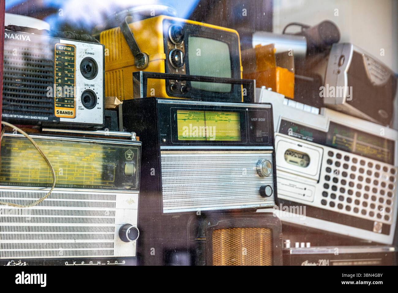 Old electronics in a dirty shop window Stock Photo - Alamy