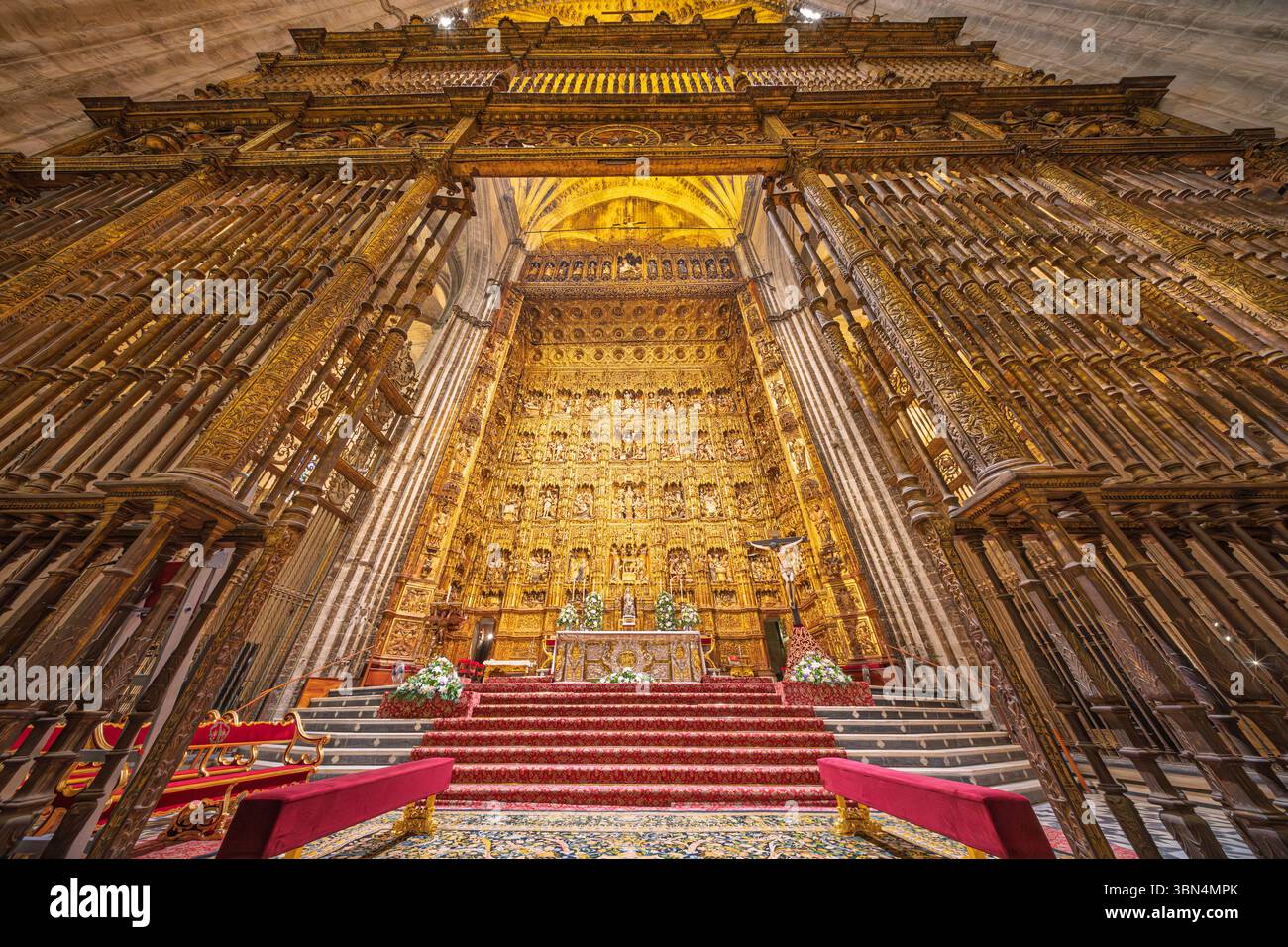 The Gothic retablo showcases intricate reliefs and a grand wrought-iron ...