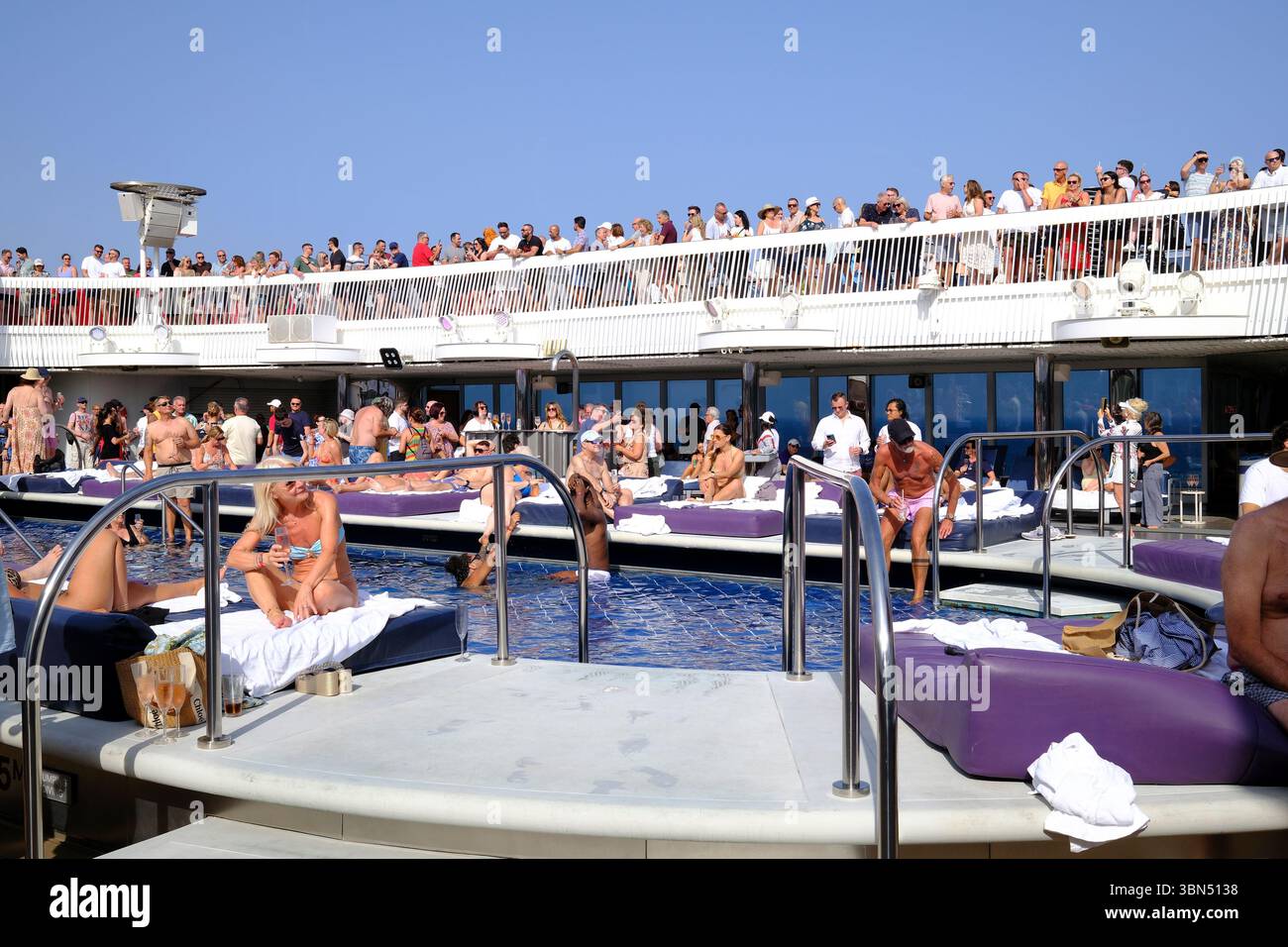 Sail away party around the pool on Virgin Voyages Scarlet Lady Stock ...