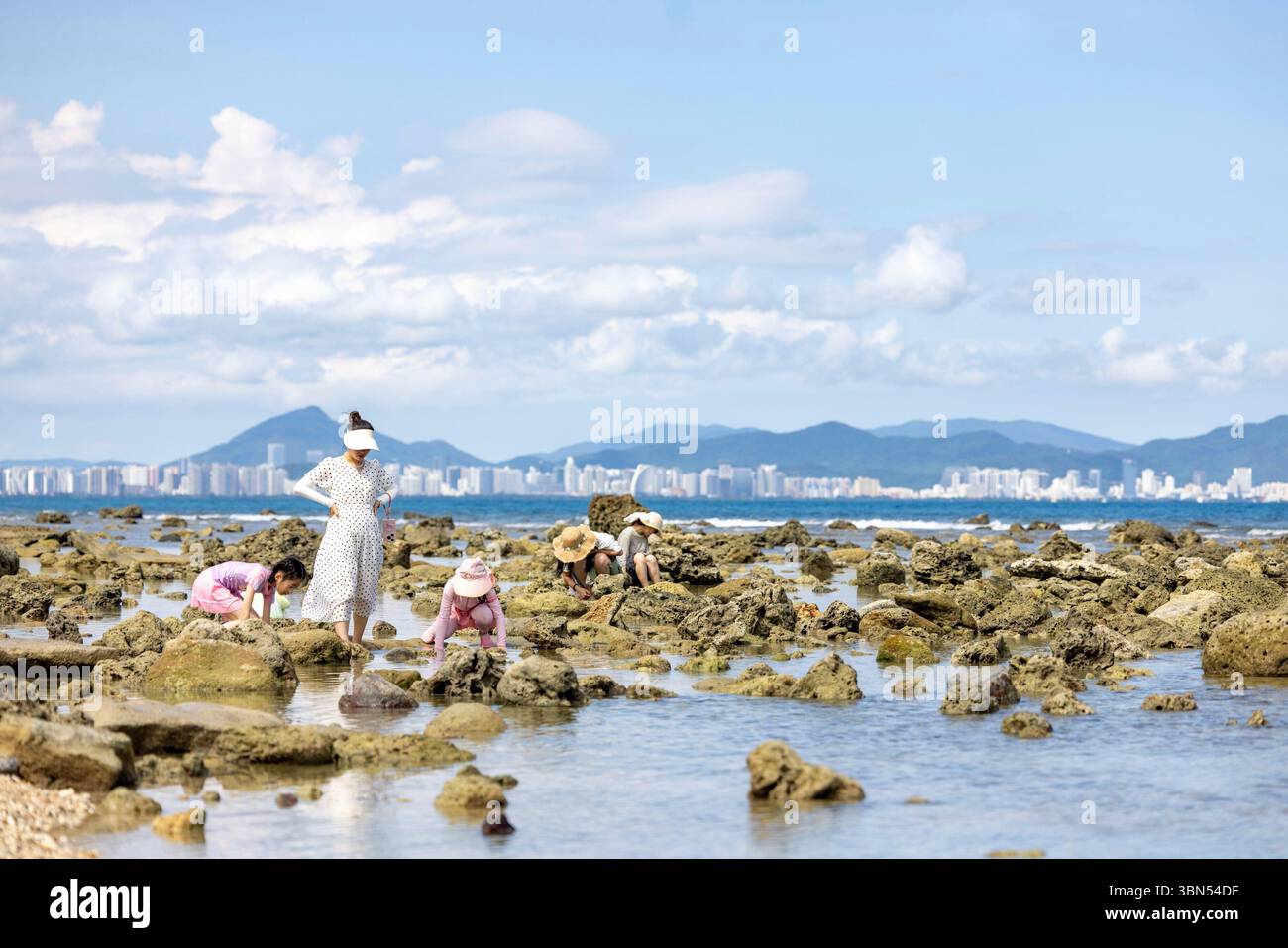 IMAGE DISTRIBUTED FOR HAINAN TOURISM - Tourists explore rock pools on ...