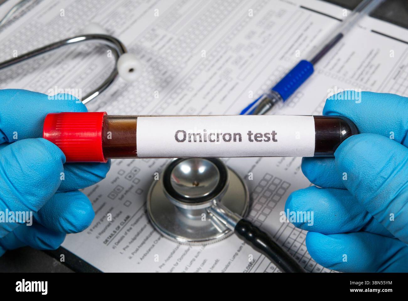 Gloved hands holding test tube labeled omicron test over medical ...