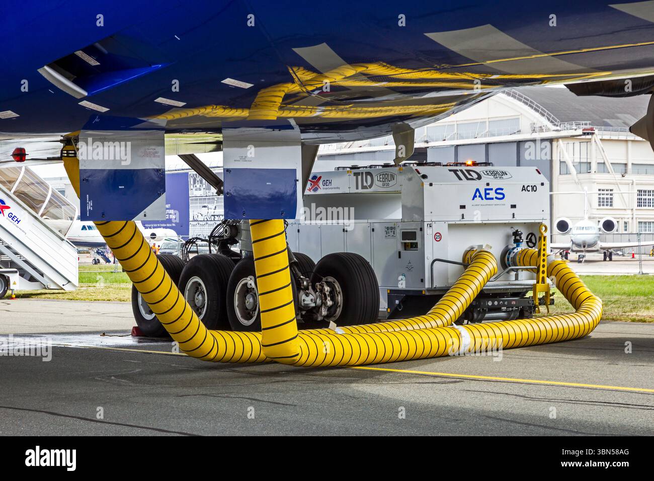 Pre-Conditioned Air (PCA) unit hoses attached to a Boeing 777 airliner ...