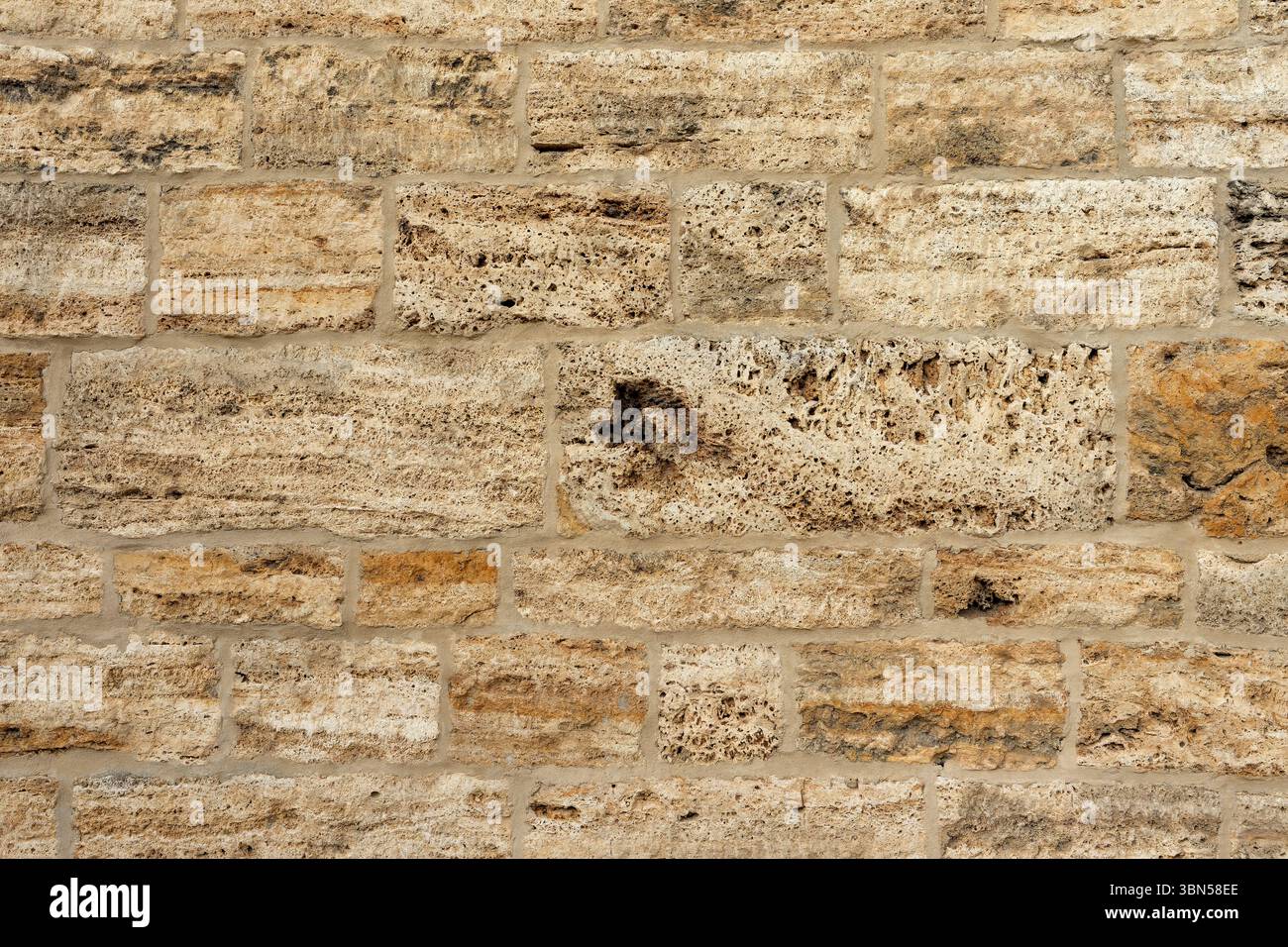 Antique beautiful stone wallю A yellow stone wall made of wild stone ...