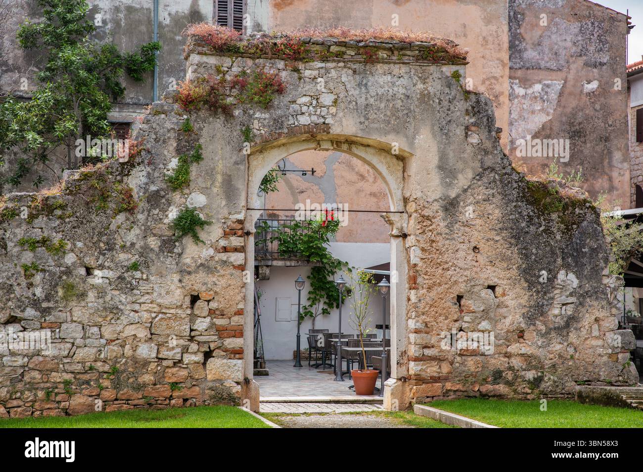 Ancient stone archway entrance to Mediterranean restaurant courtyard ...