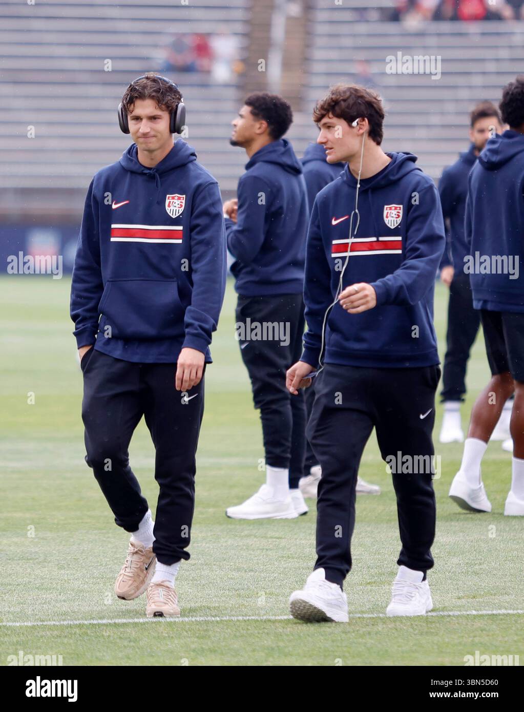 United States midfielder Brenden Aaronson, left, walks of the field ...