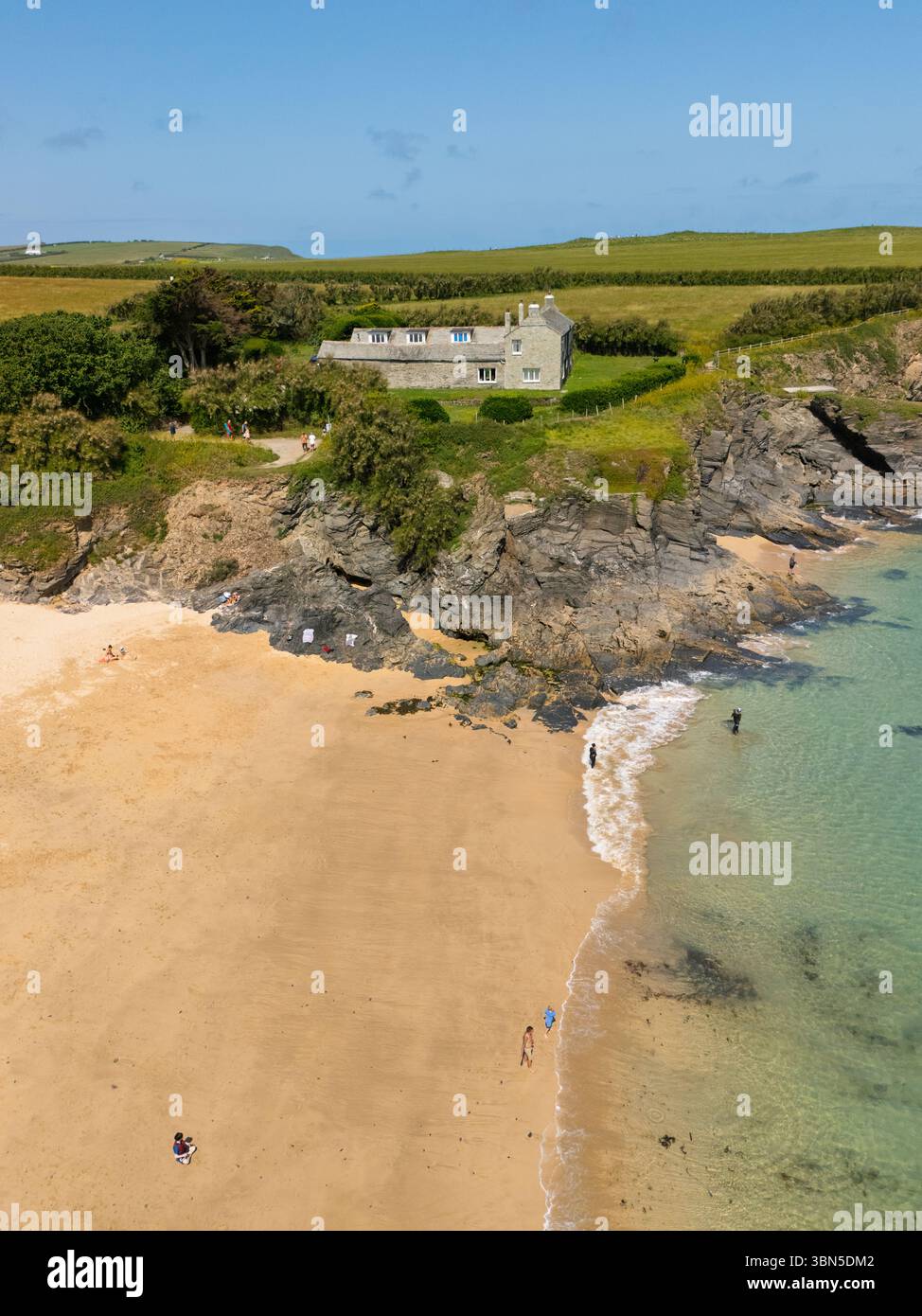 An aerial view captures the serene beauty of a beach with people ...