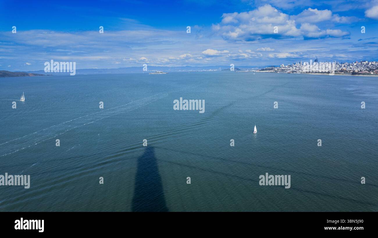 Shadow of the Golden Gate Bridge cast over the shimmering waters of San ...